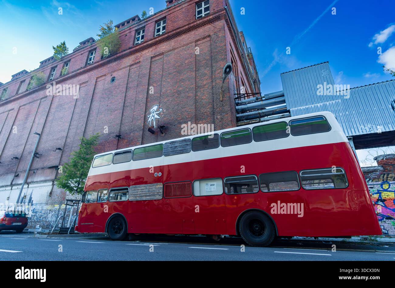 Wide-angle photograph of a red vintage double-decker bus parked in ...
