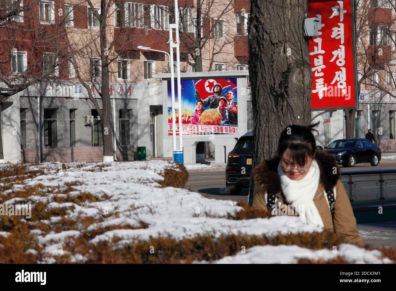 People walk in the street of the Central District, Pyongyang, North ...