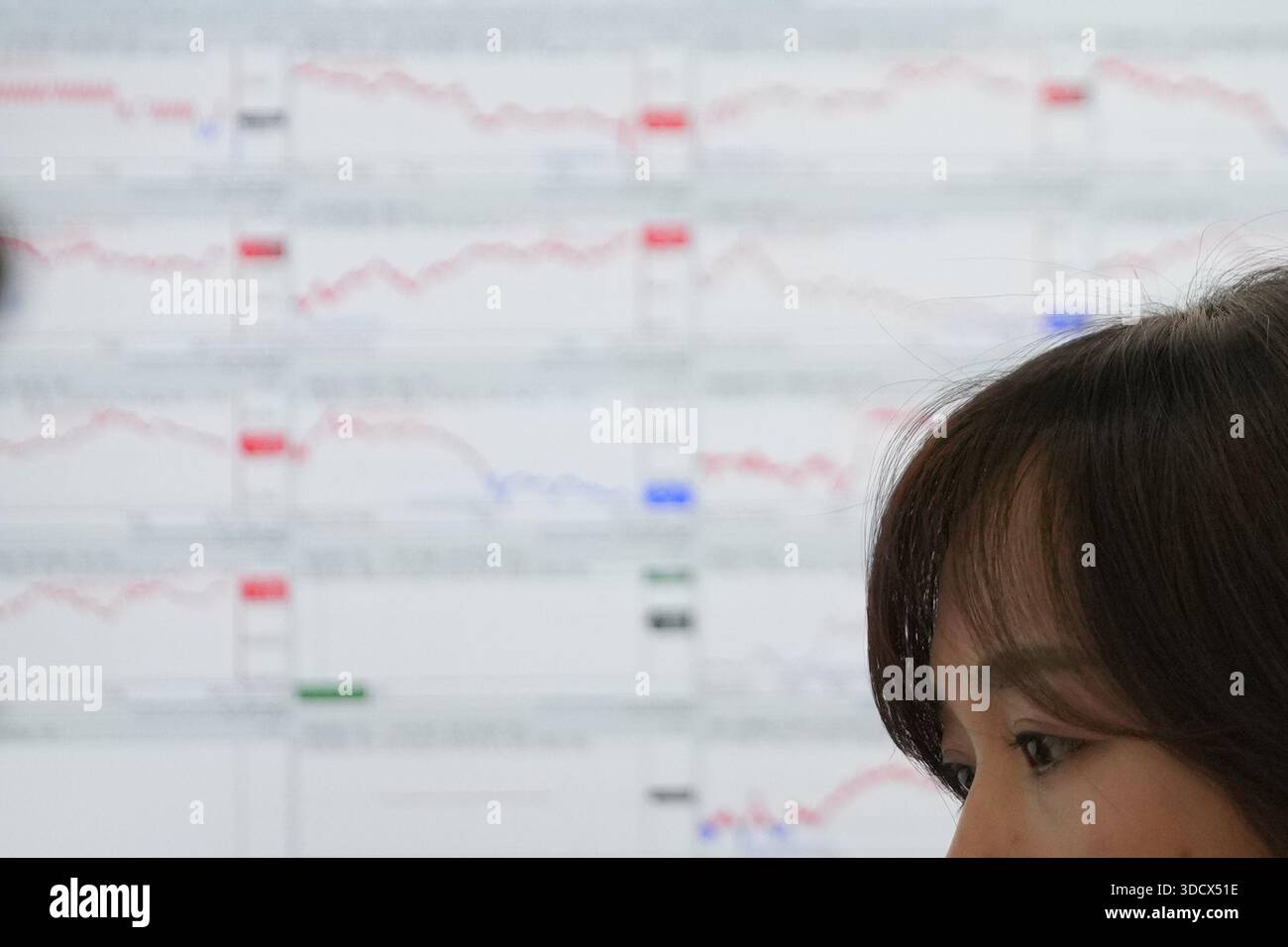 A dealer watches computer monitors at a dealing room of Hana Bank in ...