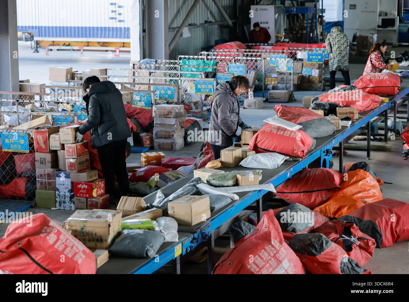 YUNCHENG, CHINA - DECEMBER 25, 2025 - Staff sort express delivery to ...