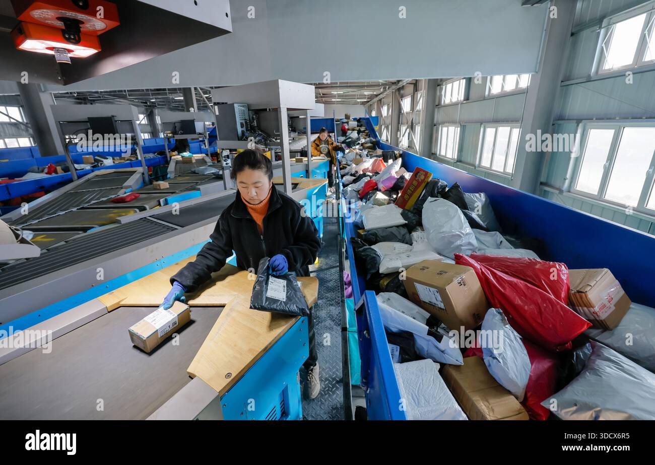 YUNCHENG, CHINA - DECEMBER 25, 2025 - Staff sort express delivery to ...