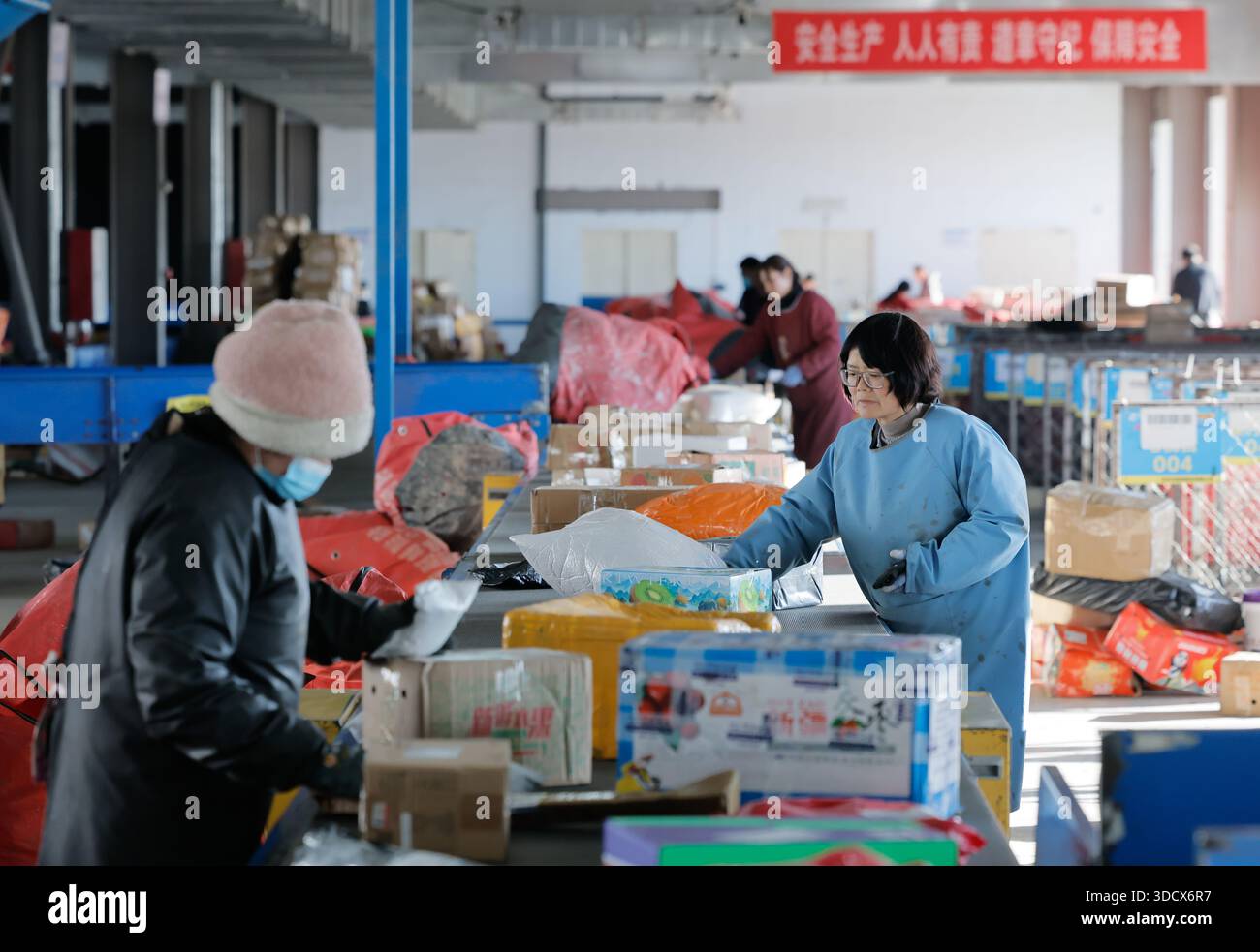 YUNCHENG, CHINA - DECEMBER 25, 2025 - Staff sort express delivery to ...