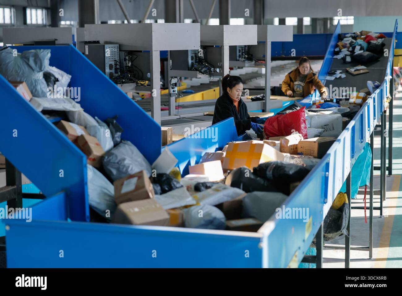YUNCHENG, CHINA - DECEMBER 25, 2025 - Staff sort express delivery to ...