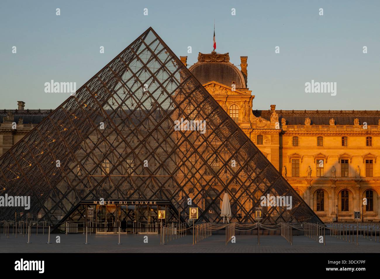 Sunset view of the Louvre Museum in Paris, France, featuring the iconic ...
