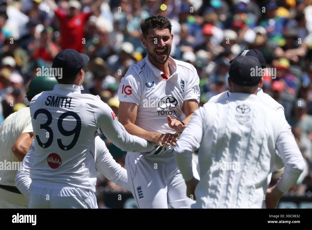 England's Josh Tongue, center, celebrates with teammates after taking ...