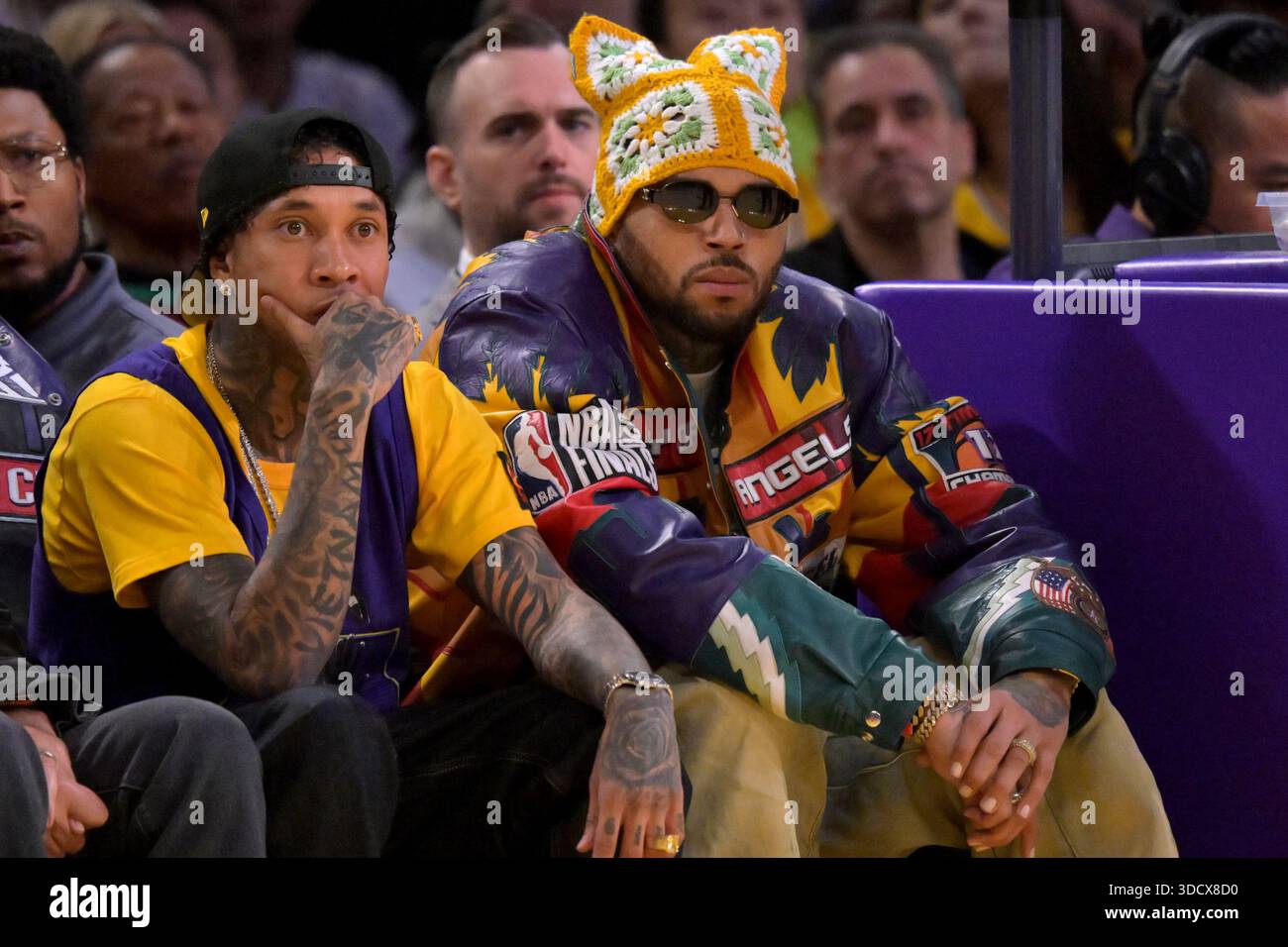 Rappers Tyga, left, and Chris Brown attend an NBA basketball game ...