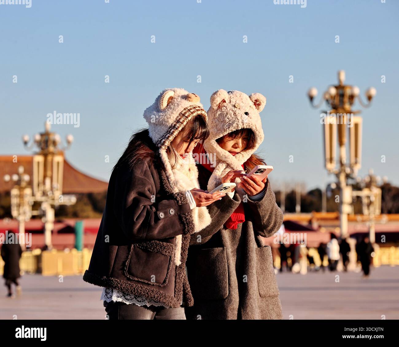 Tourists wear thick clothes visiting Tiananmen Square in Beijing, China ...