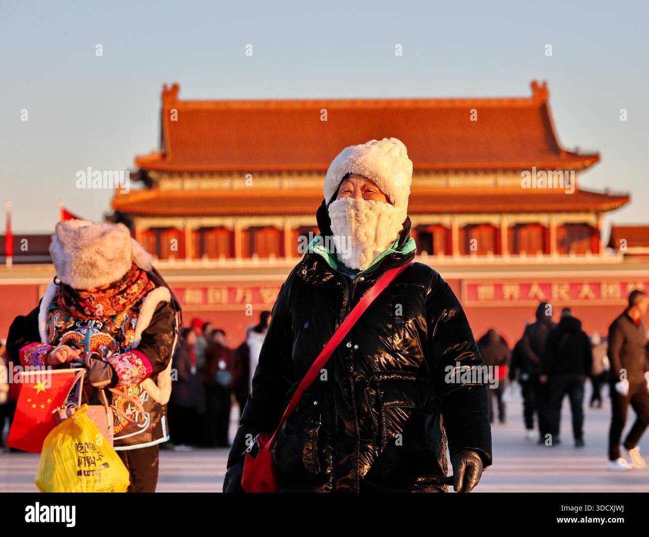 Tourists wear thick clothes visiting Tiananmen Square in Beijing, China ...
