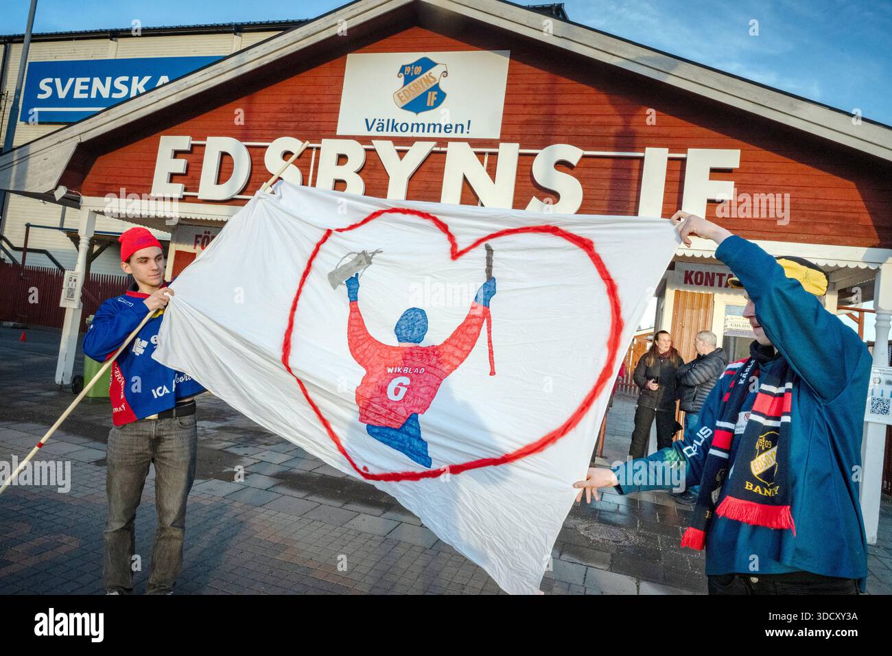 EDSBYN, SWEDEN 20251226 Edsbyns fans warm up before Friday's bandy ...