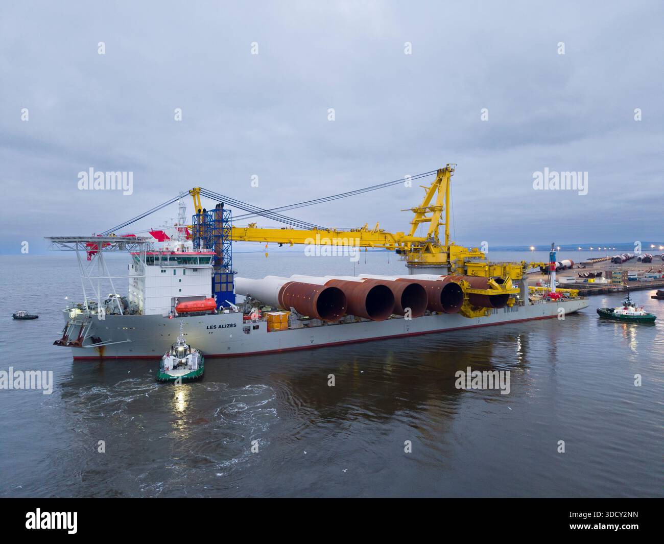MV Les Alizes, loads wind turbine monopiles at Leith Port. The piles ...