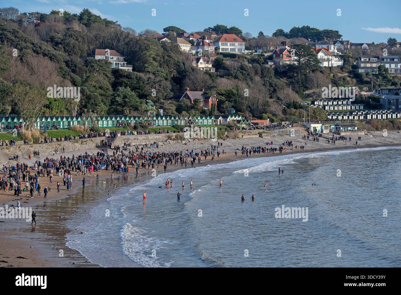 Crowds of people brave the chilly weather at Langland Bay, Swansea ...