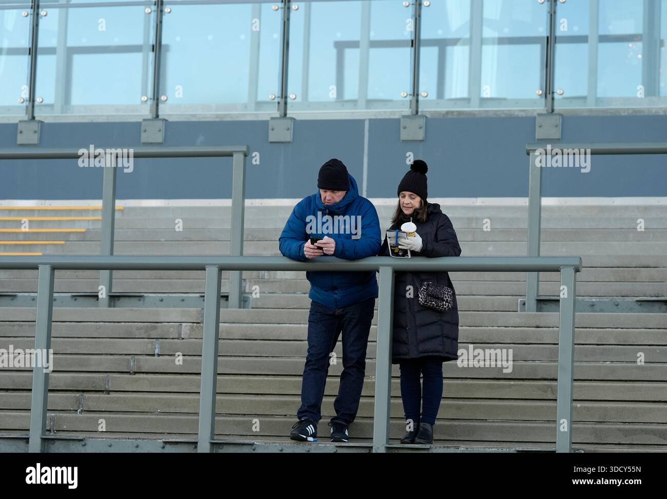 Punters check the form ahead of the next race at Aintree Racecourse ...