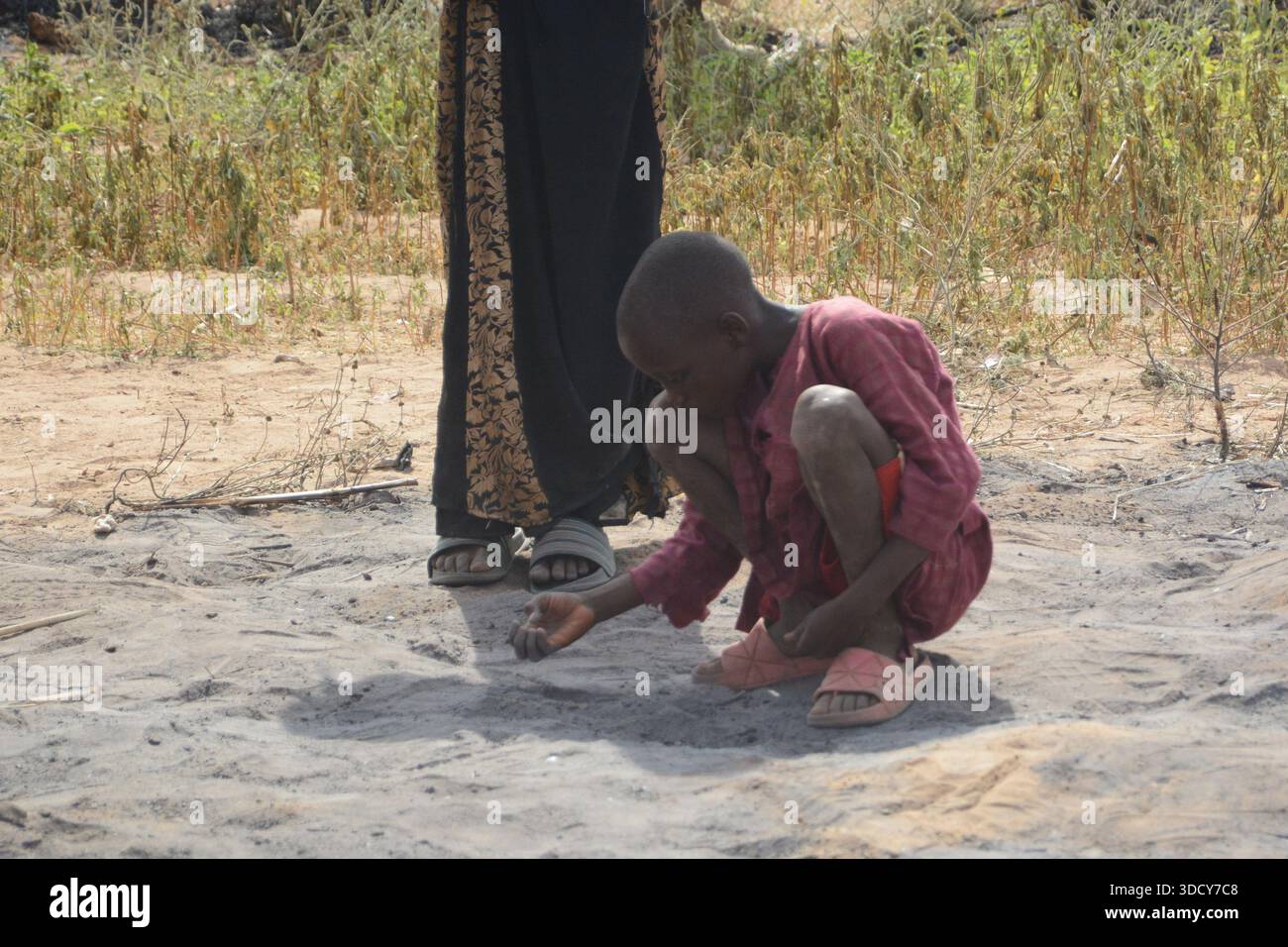 A boy picks debris at the site of a U.S. airstrike in Northwest, Jabo ...