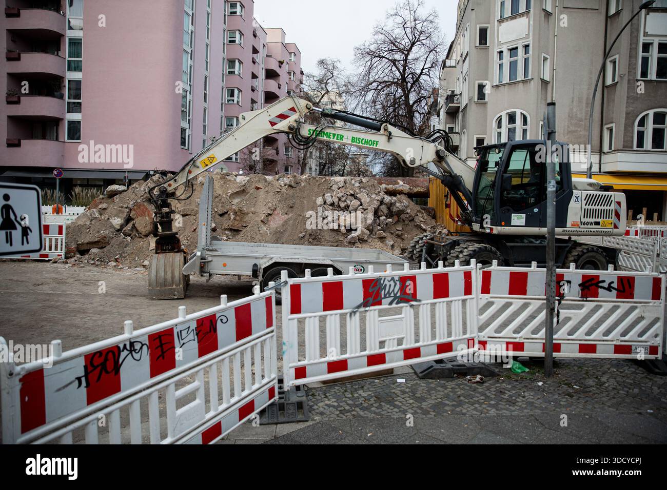 On December 26, 2025, an excavator and piles of rubble sit idle at a ...