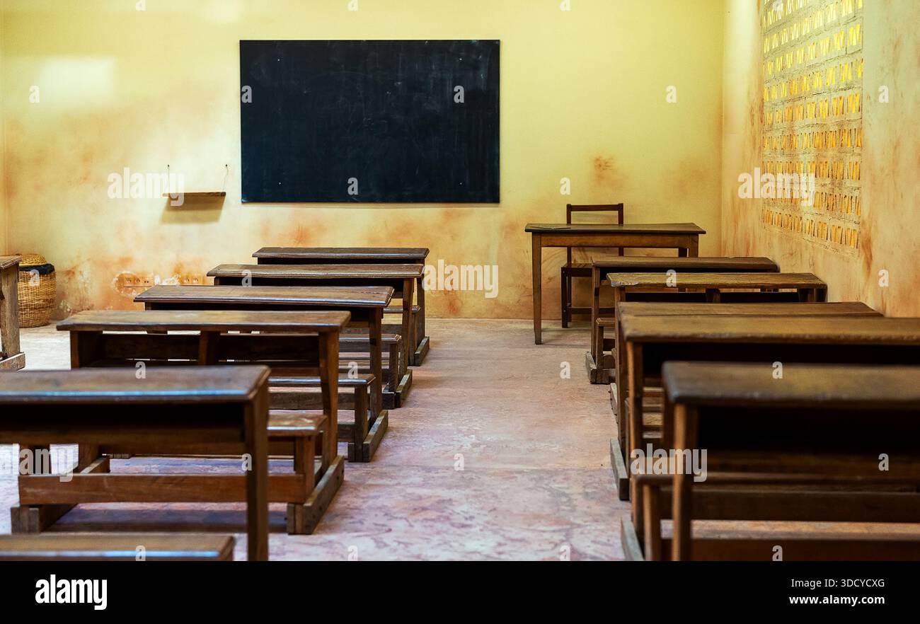 Interior of a traditional African classroom with wooden desks and a ...