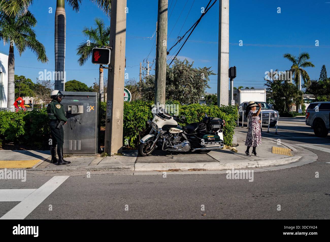 A supporter waves as the motorcade for President Donald Trump rolls to ...