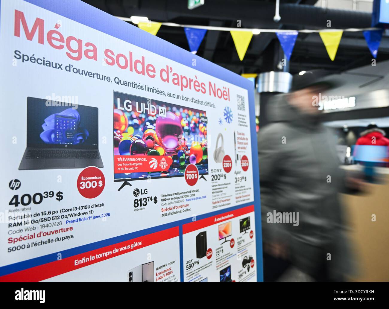 A person walks by a sign advertising big discounts at a Best Buy ...