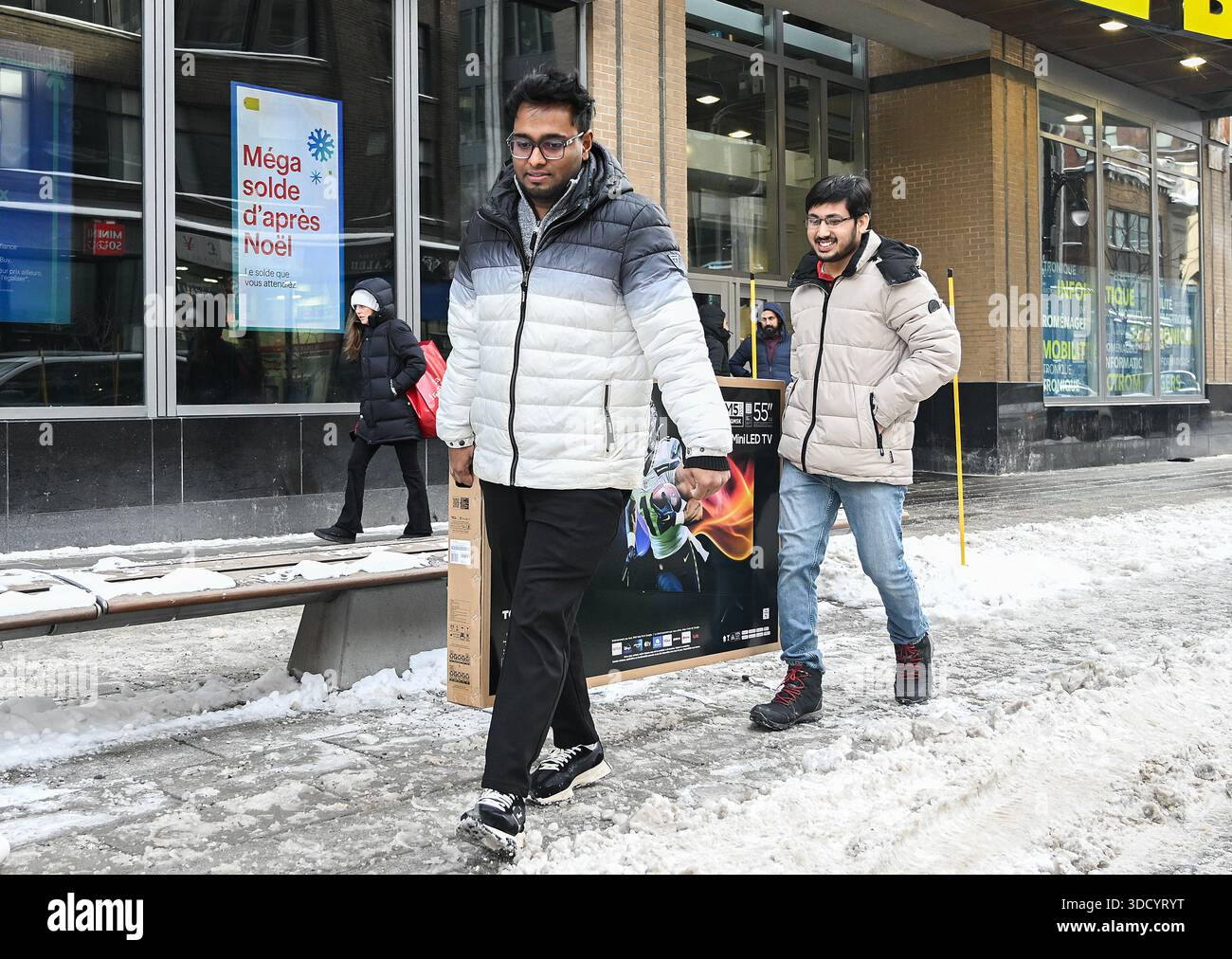 Two men carry a large screen television from a Best Buy store on Boxing ...