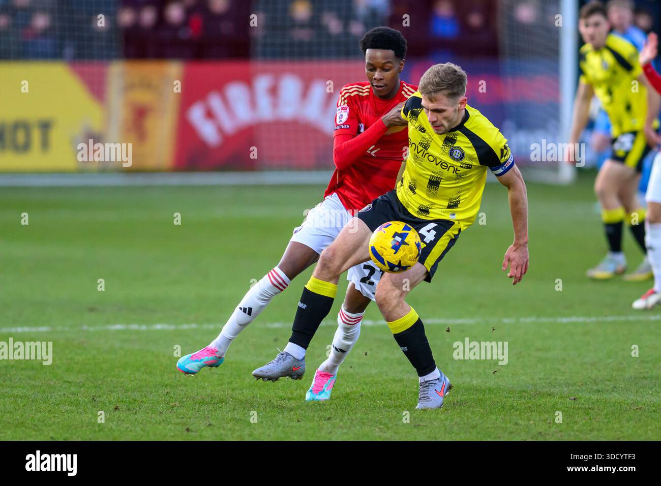 Kallum Cesay of Salford City FC tackles Jack Evans of Harrogate Town ...