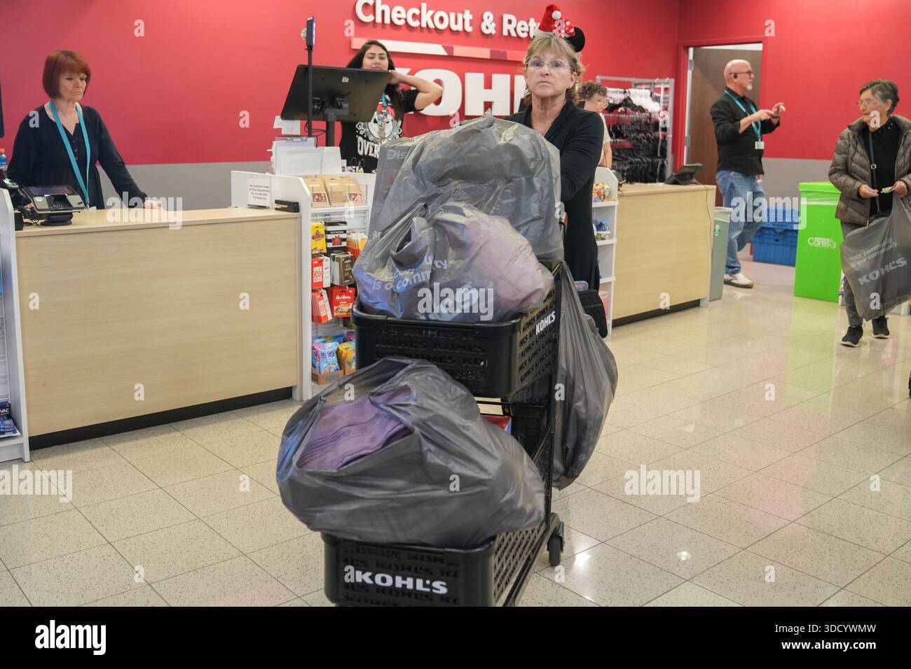FILE - A shopper loads a cart full at Kohl's department store for Black ...