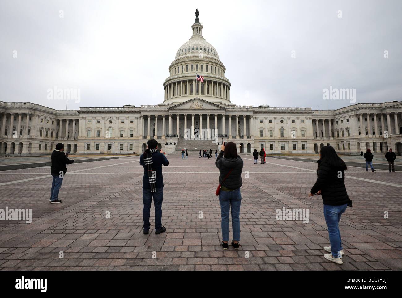 Tourists are seen on the East Front at the U.S. Capitol, Friday, Dec ...