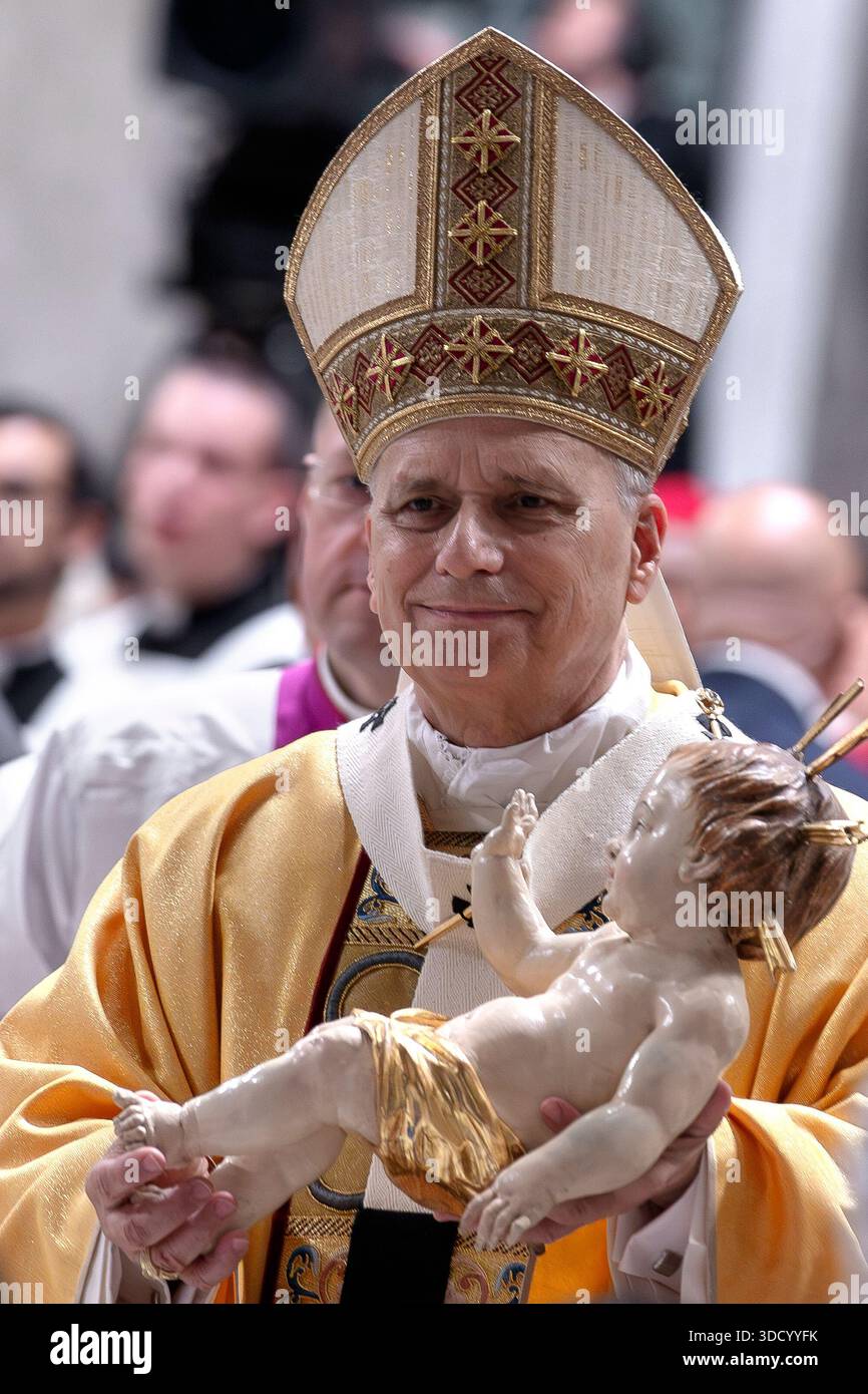 Pope Leo XIV carries the Baby Jesus to a nativity scene in St. Peter's ...