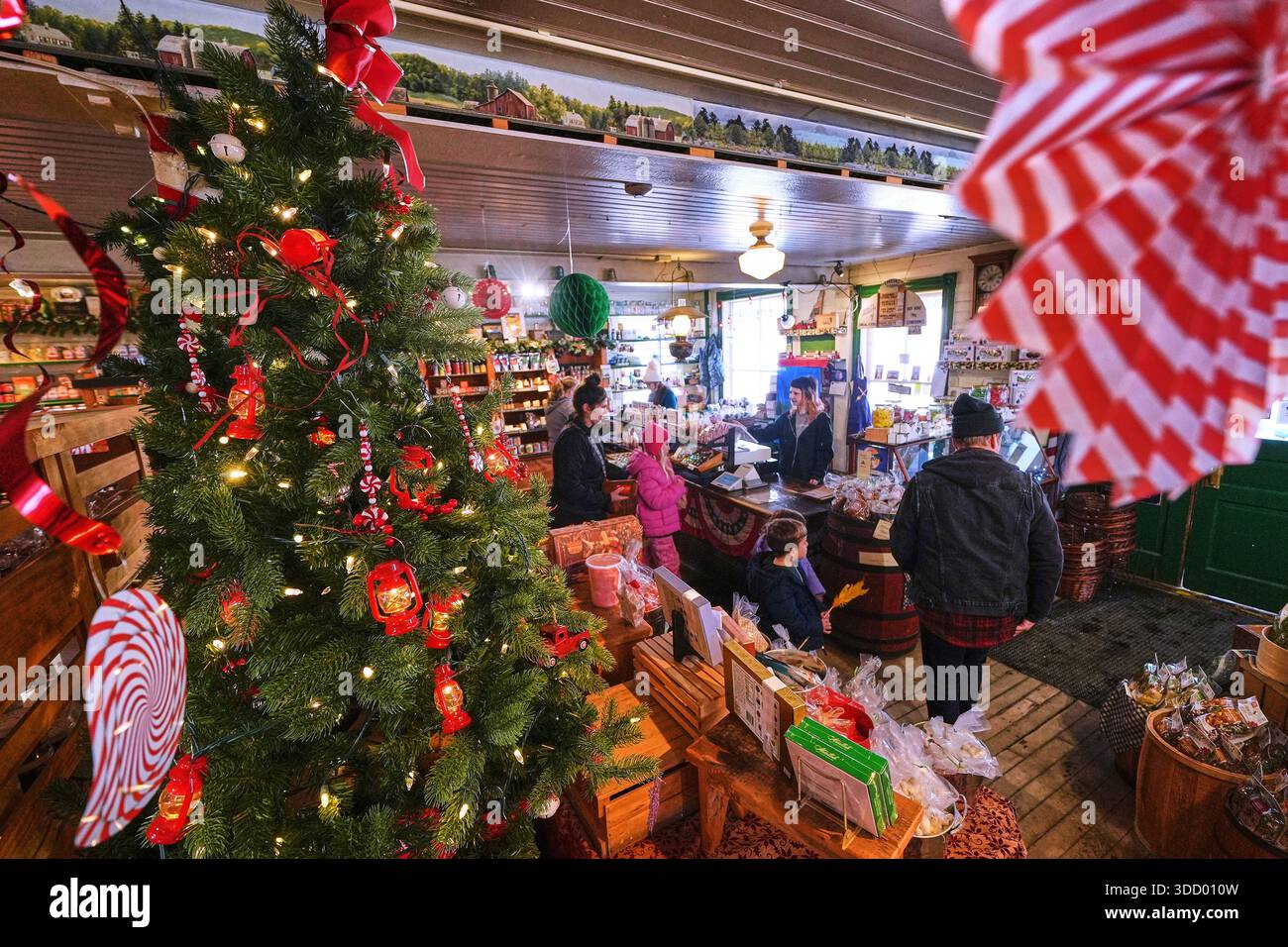 Post-holiday shoppers pass a Christmas tree at Calef's Country Store ...