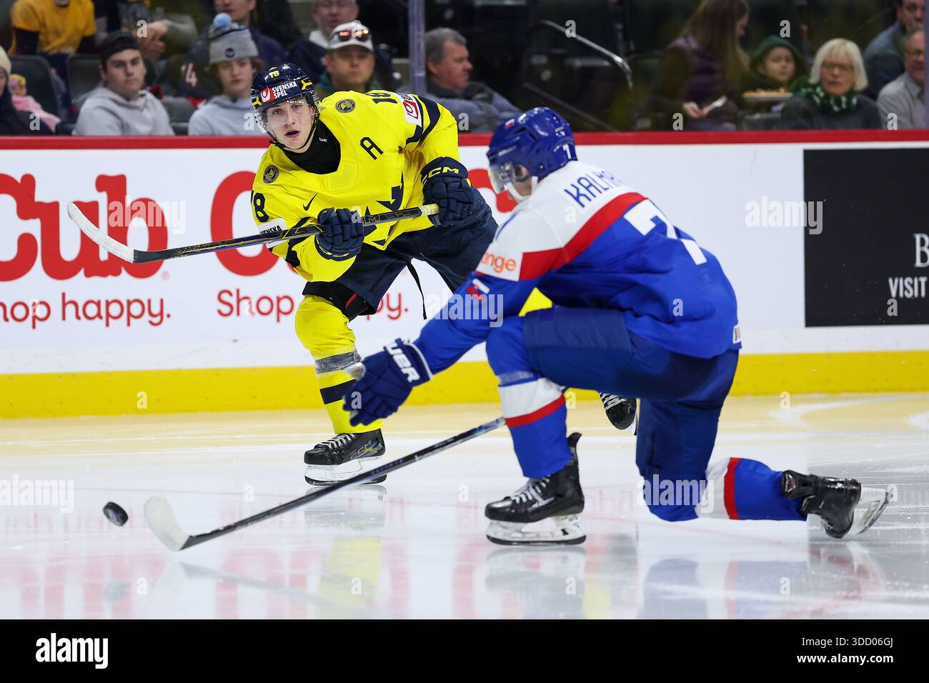 Sweden forward Victor Eklund, left, shoots the puck as Slovakia ...