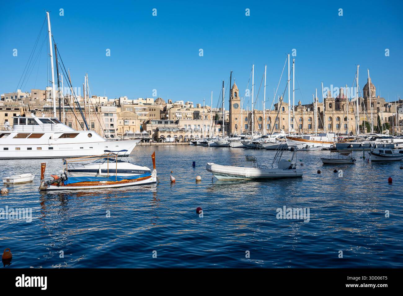 View over Birgu harbor with pleasure boats, historic monuments, and ...