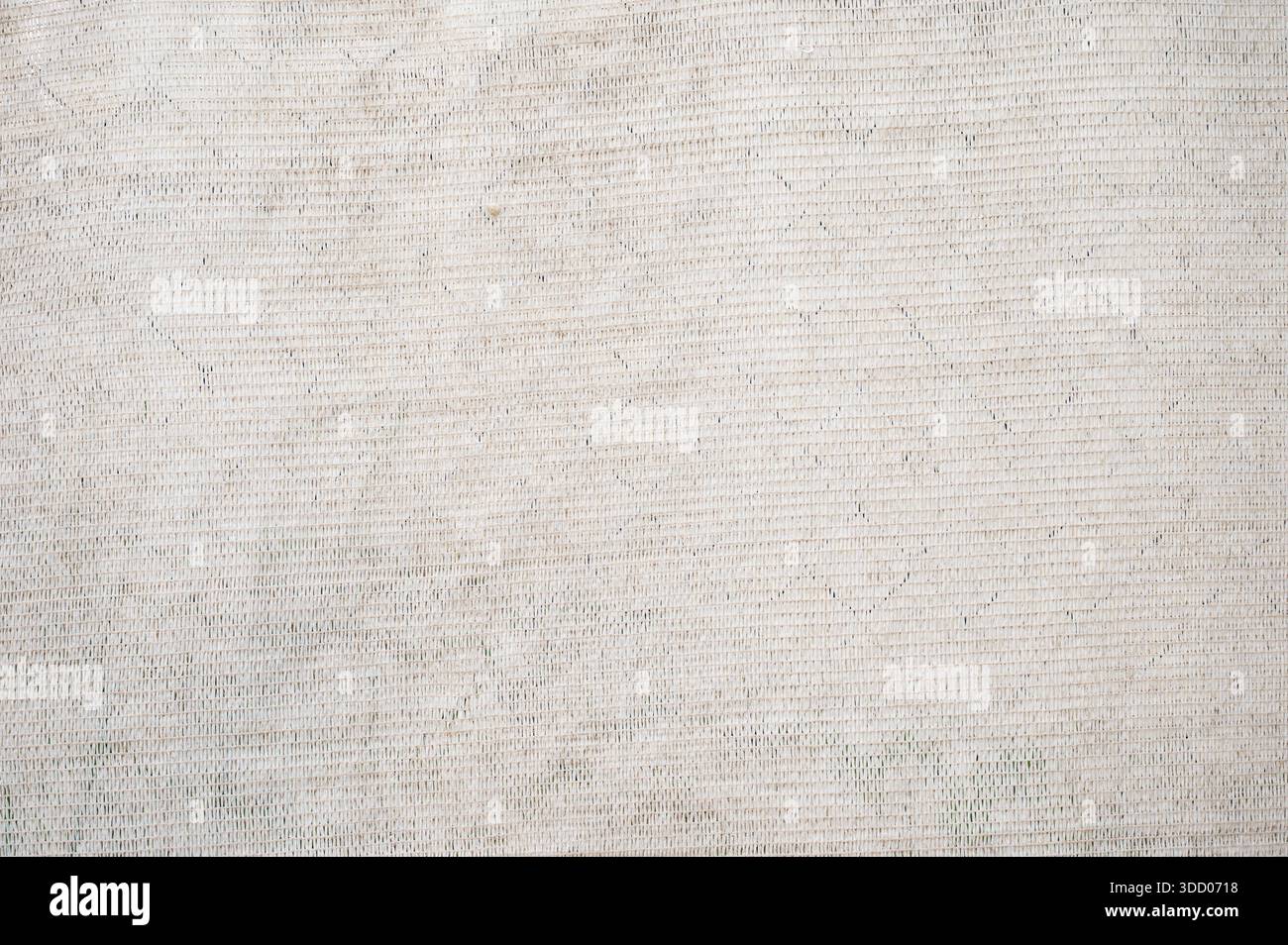 Textured background made of woven textile and reed elements in light ...