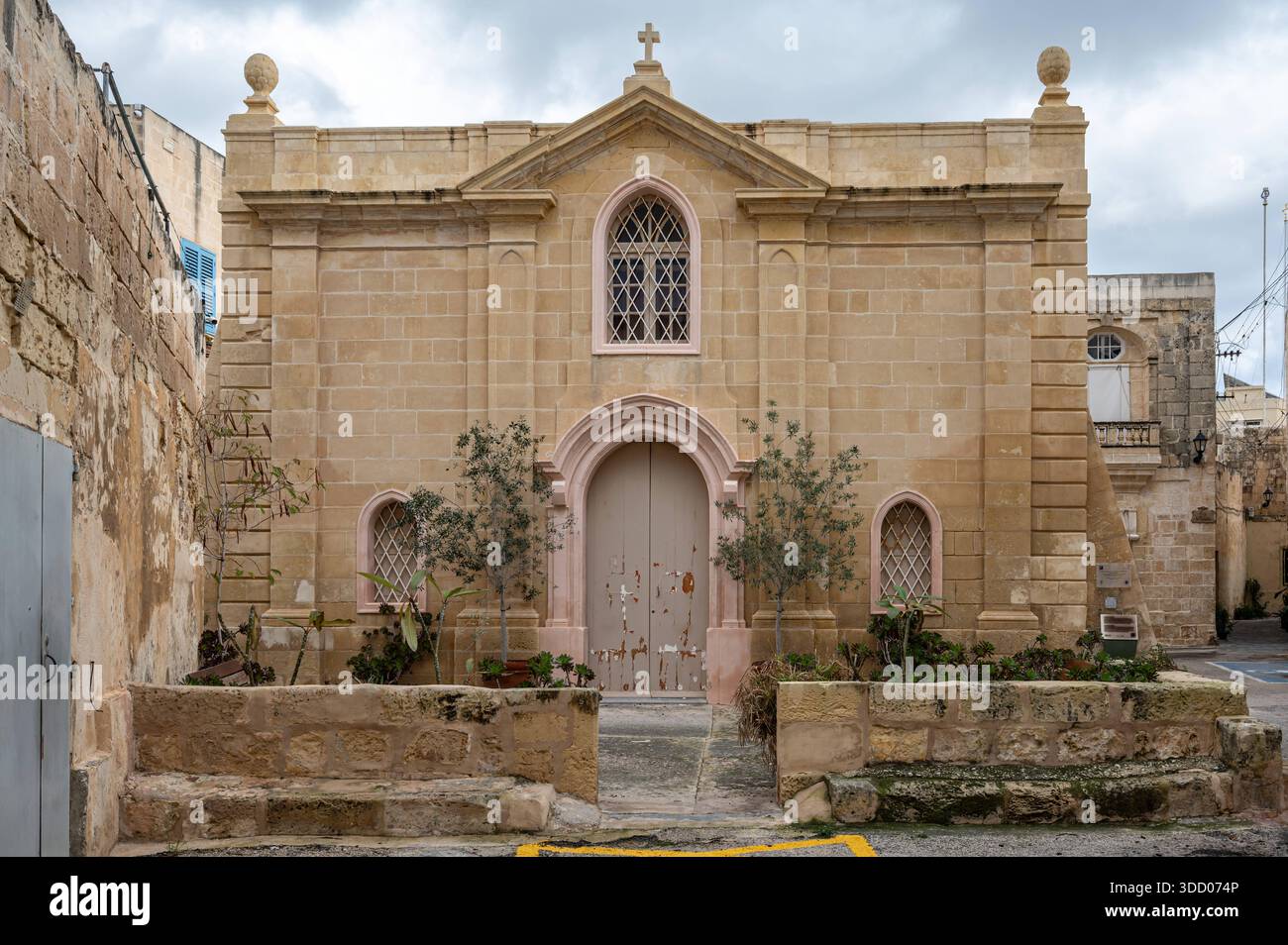 Narrow streets lined with simple houses featuring colorful wooden doors ...