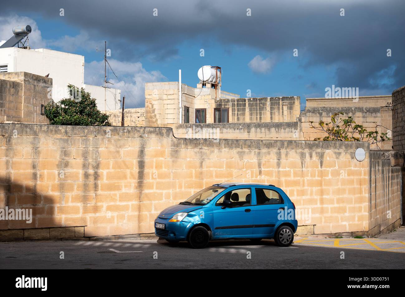 Narrow streets lined with simple houses featuring colorful wooden doors ...