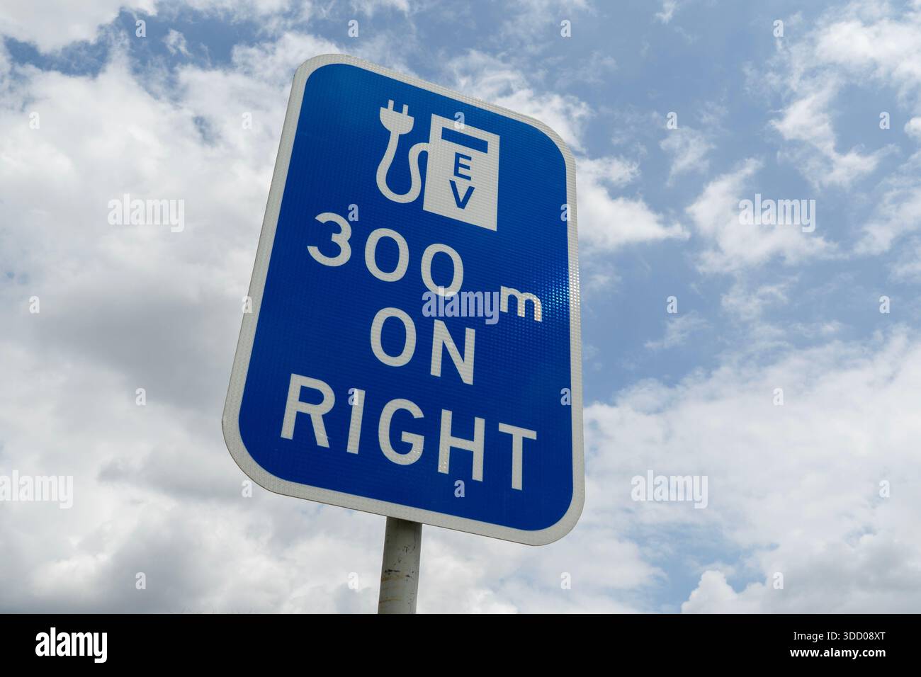 EV electric vehicle charging sign, 300 meters ahead on the right. White ...