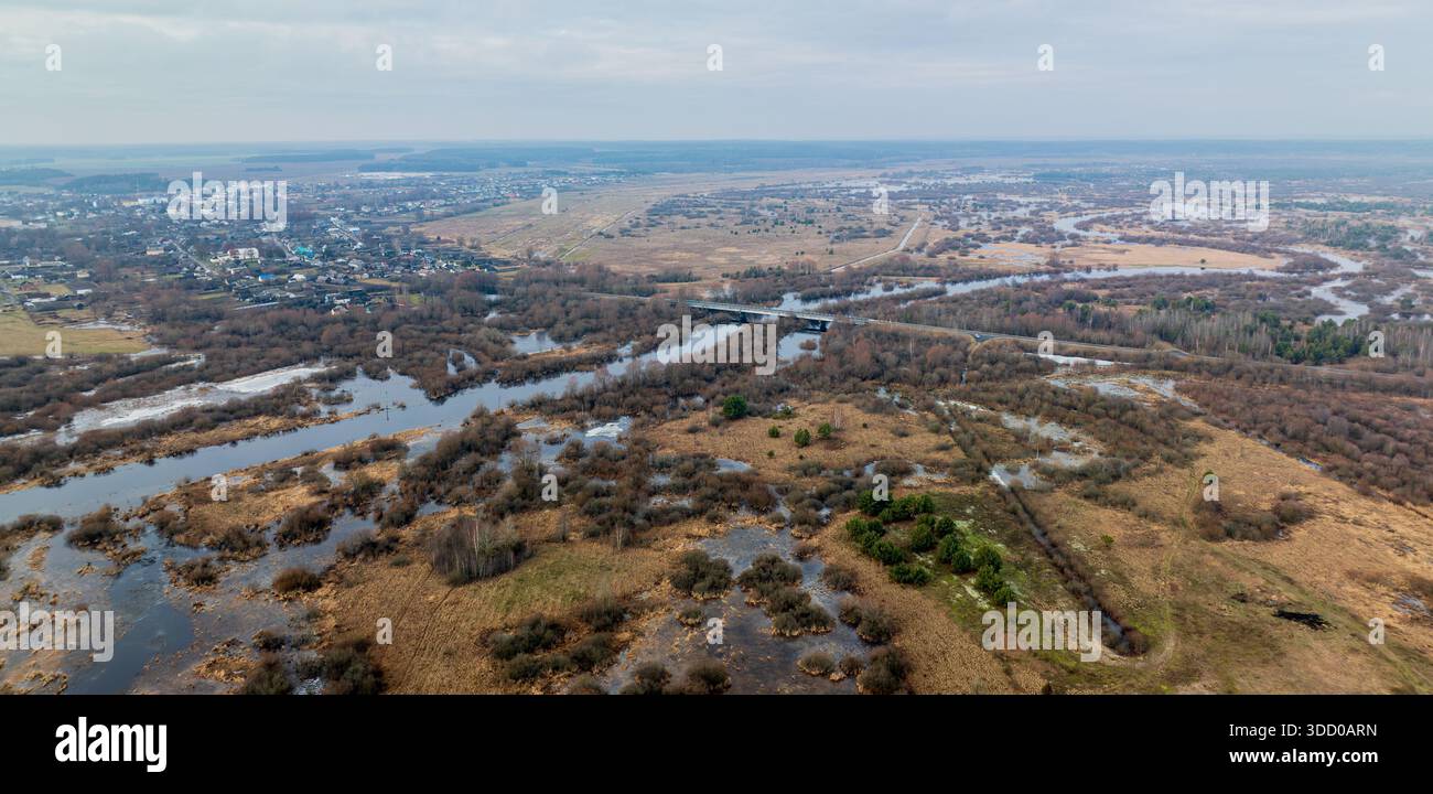 Aerial scene in Belarus shows a bridge over wetlands, winding rivers ...
