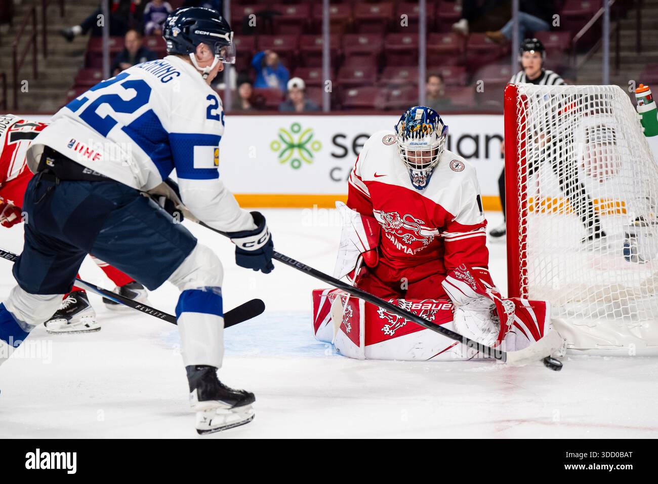 Finland's Emil Hemming (22) shoots on Denmark goalie Anton Wilde during second period IIHF World ...
