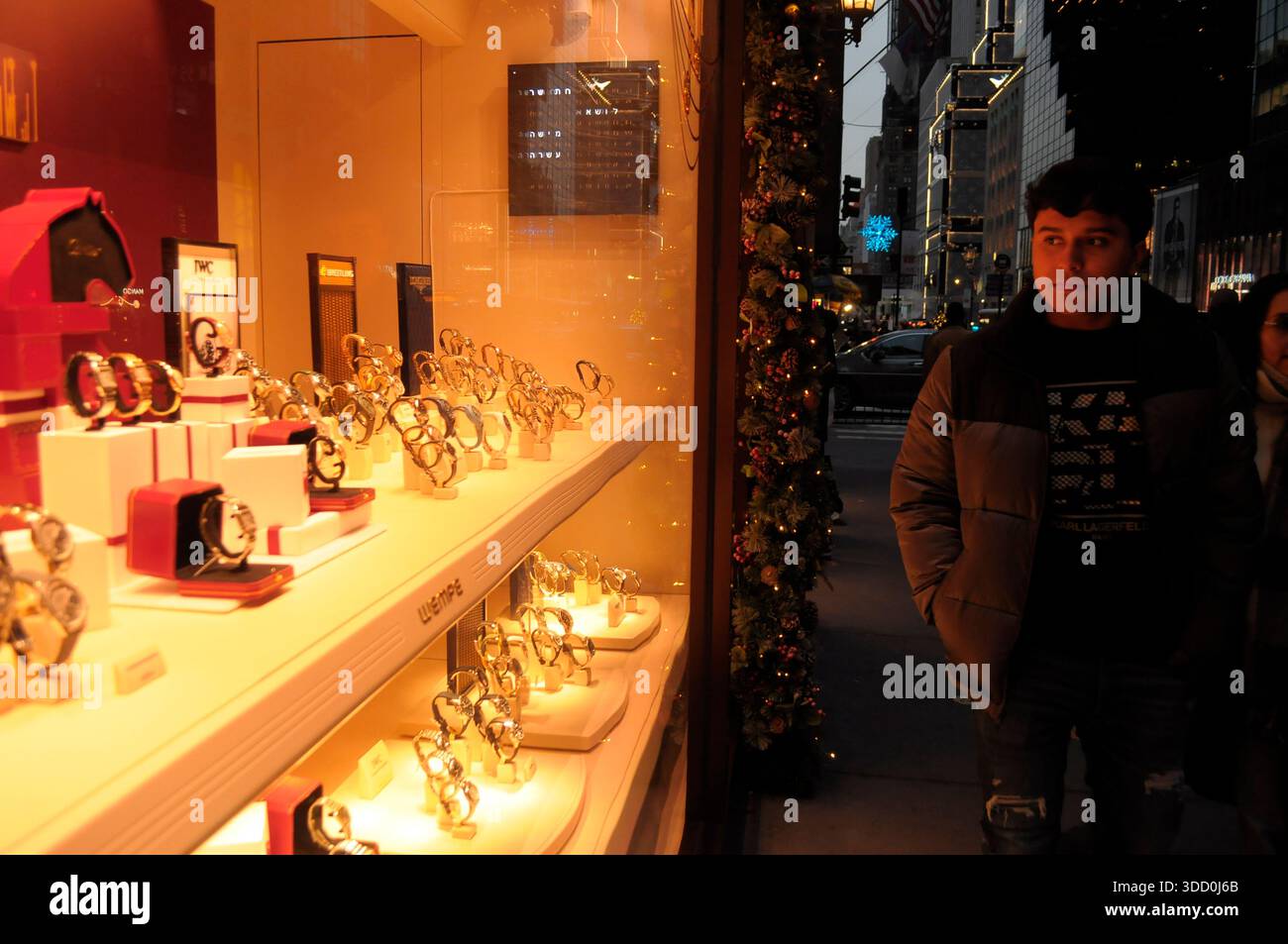 A person walks past watches in a window display at the Wempe Jewelers ...