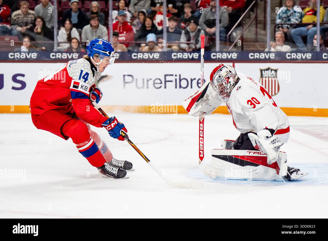 Canada goaltender Carter George (30) makes a save on Czechia's Vaclav ...