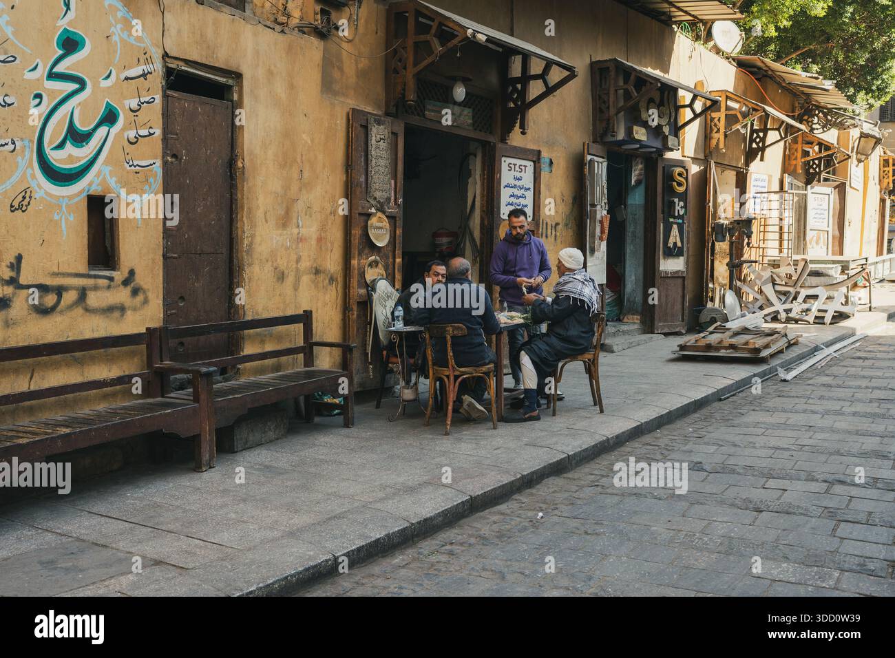 Egyptian men at a table in the street of Cairo. (Photo by Lounis Tiar ...