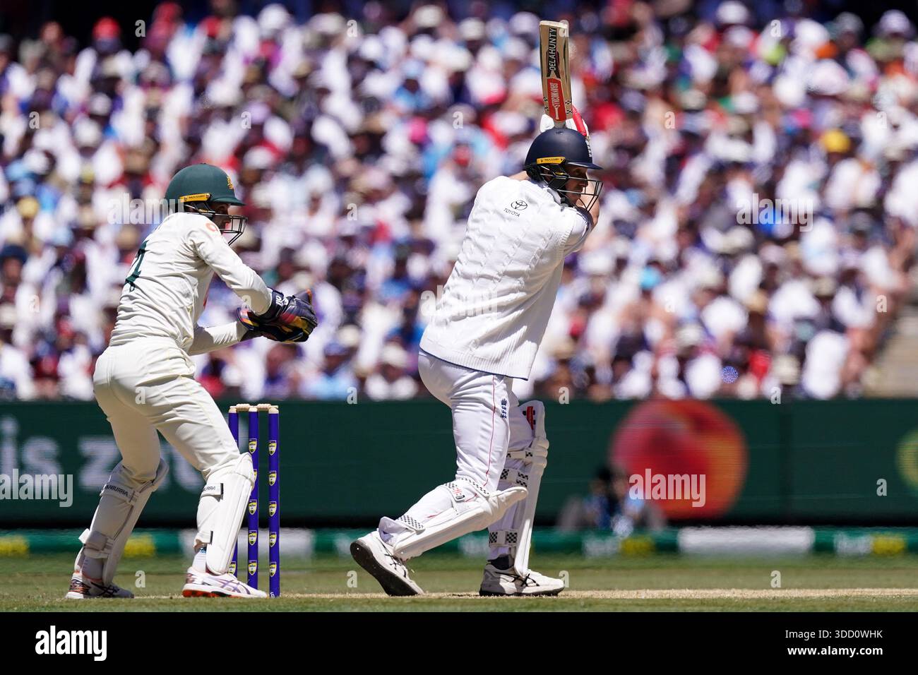 England's Zak Crawley (right) bats with Australia's Alex Carey (left ...