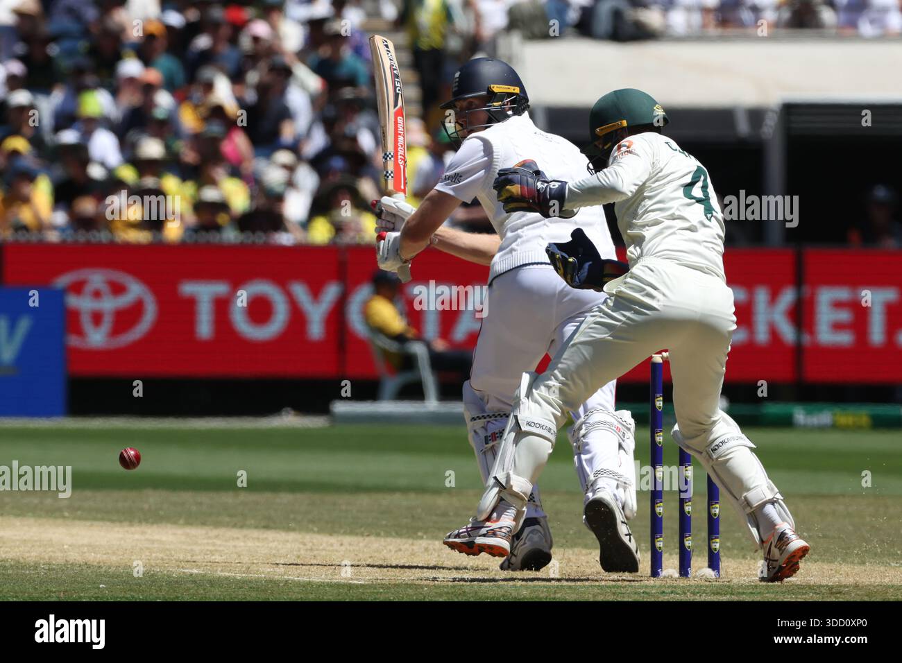 England's Zak Crawley, left, bats in front of Australia's Alex Carey on ...