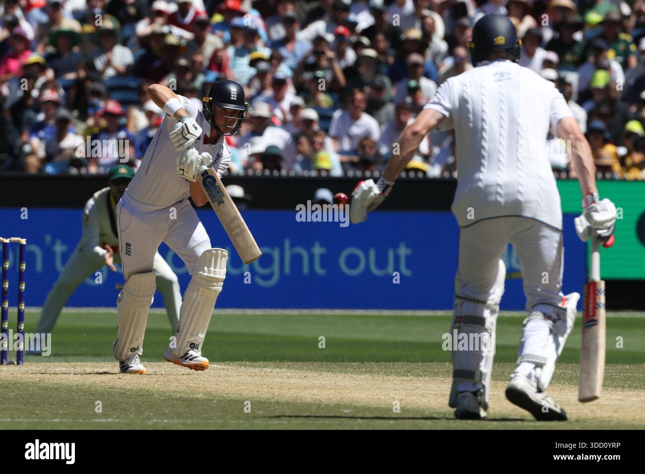 England's Jacob Bethell, left, drives the ball past his partner, Zak ...