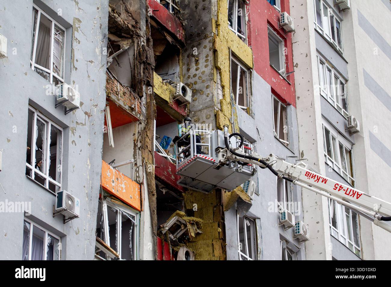 Rescuers from Ukraine’s State Emergency Service use an aerial work ...