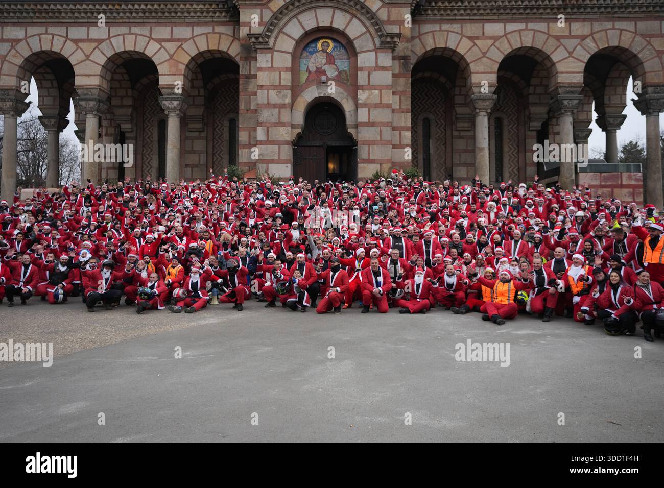 Bikers wearing Santa Claus pose in front of St. Marco's church prior to ...