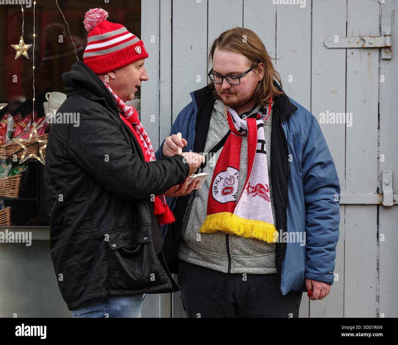 Liverpool fans take a bite to eat during the Premier League match ...