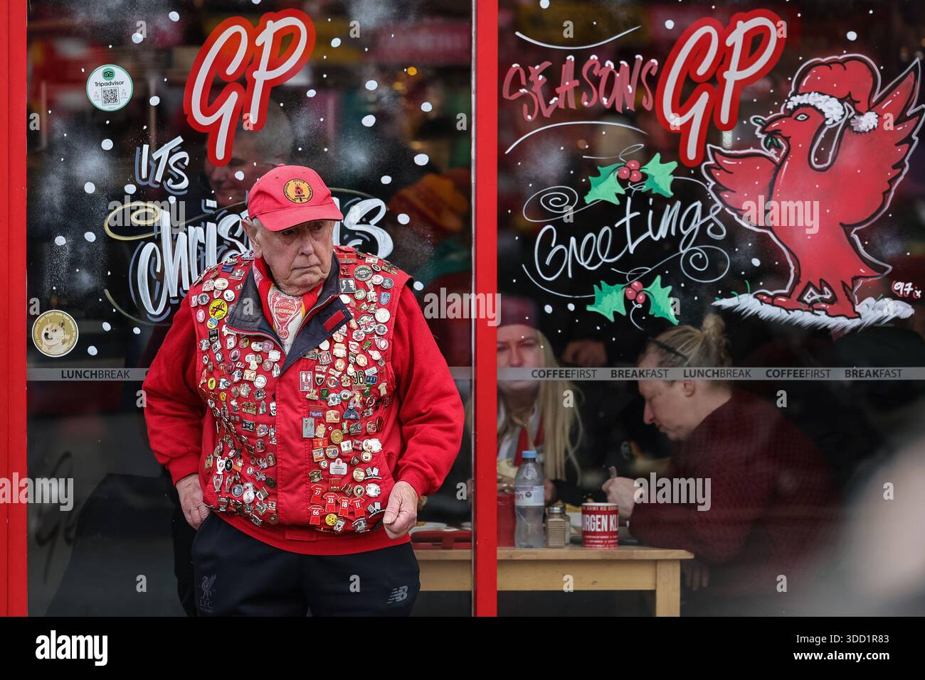 A Liverpool fan with his coat covered in pin badges during the Premier ...