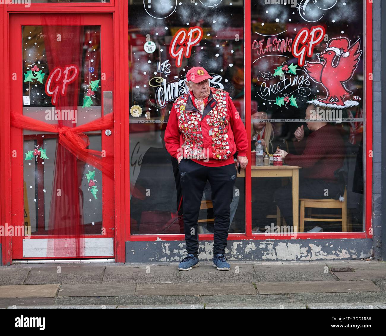 A Liverpool fan with his coat covered in pin badges during the Premier ...