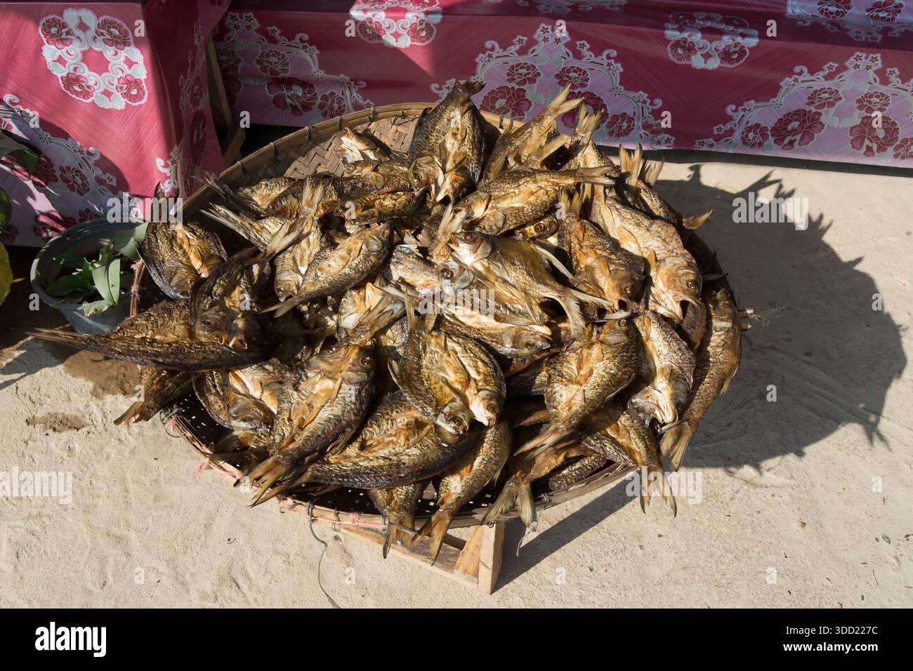 fish for sale from a basket at a roadside market in vang vieng, laos ...