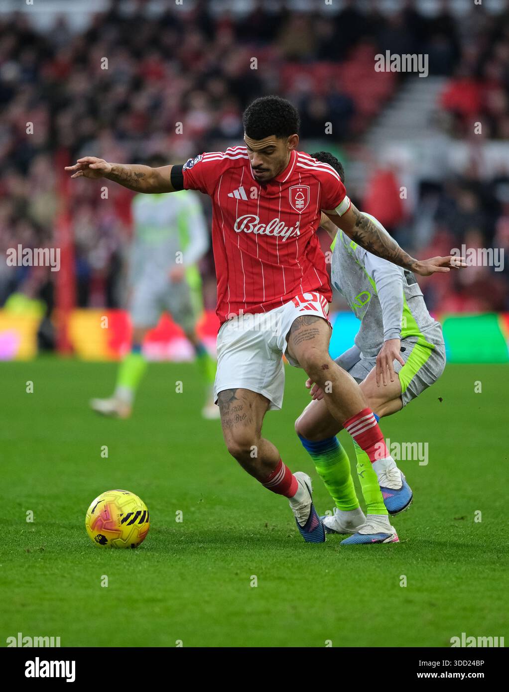 Morgan Gibbs-White of Nottingham Forest competes for the ball with Phil ...