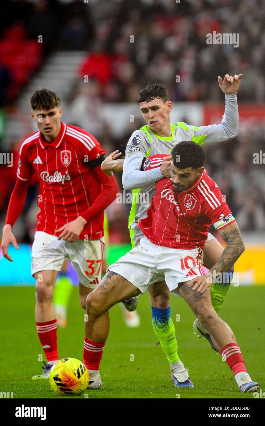 Morgan Gibbs-White of Nottingham Forest holds off Phil Foden of ...