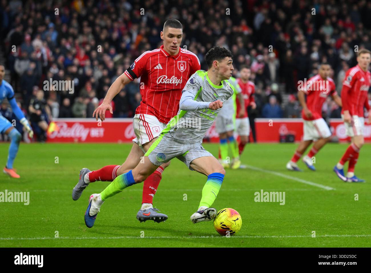 Phil Foden of Manchester City under pressure from Nikola Milenkovic of ...